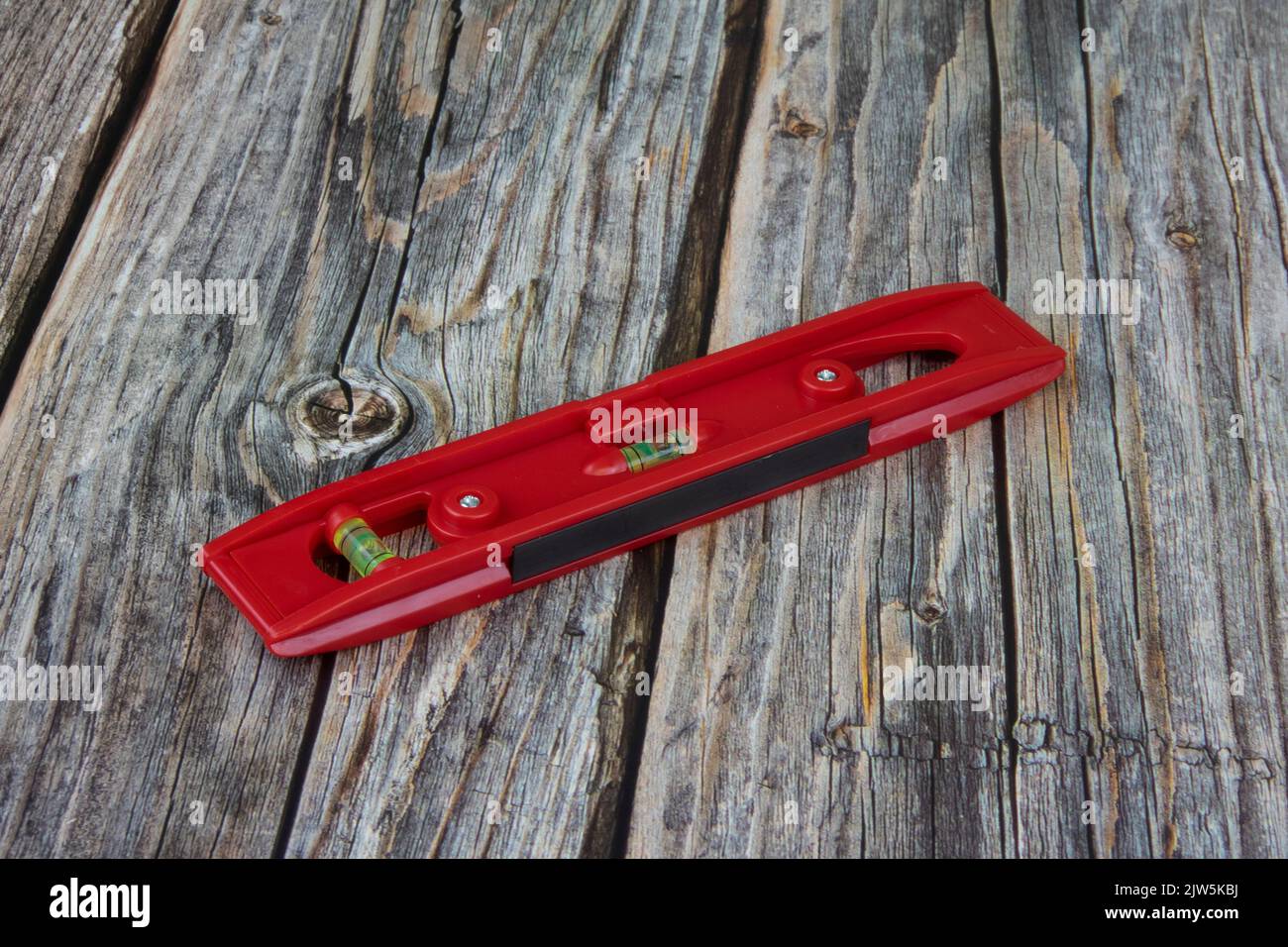 A closeup of red magnetic torpedo on a wooden background Stock Photo ...