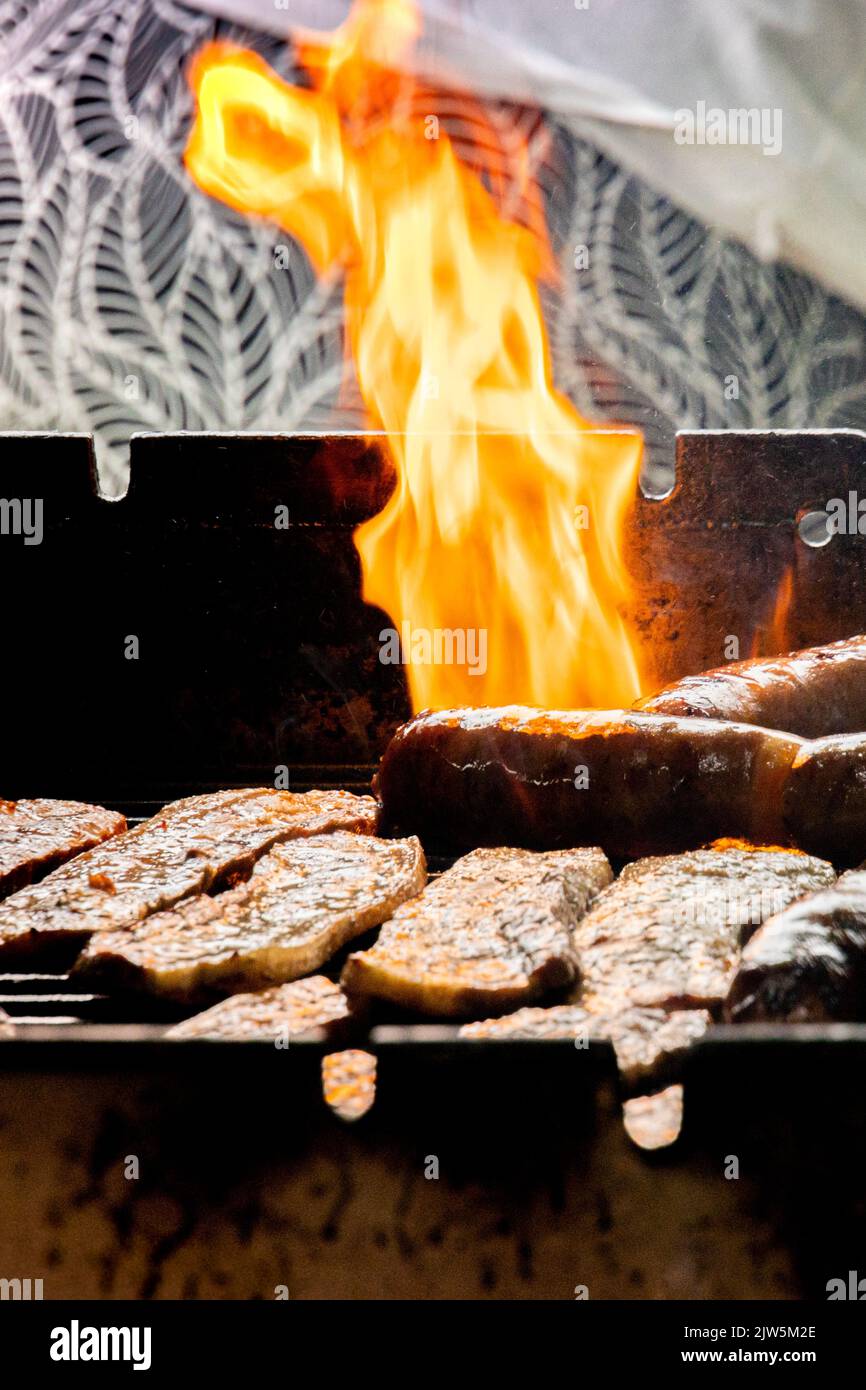 fire coming out of the barbecue with meat and the danger of fire Stock ...