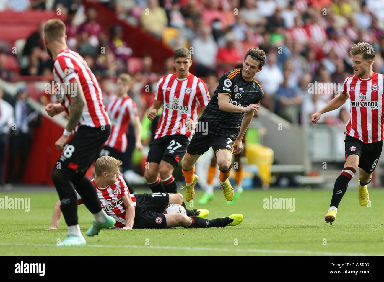 Ben Mee #16 of Brentford tackles Brenden Aaronson #7 of Leeds United ...