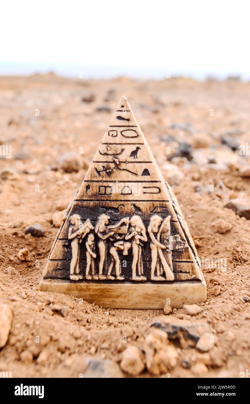 An Egyptian Pyramid model miniature in the rocky desert Stock Photo - Alamy
