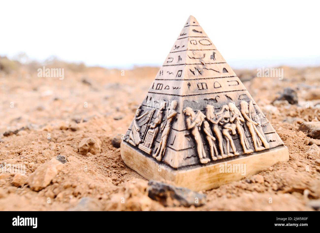 An Egyptian Pyramid model miniature in the rocky desert Stock Photo - Alamy