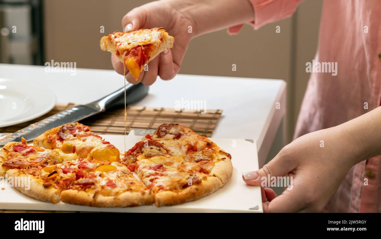 Hand cutting pizza table cheese hi-res stock photography and images - Alamy