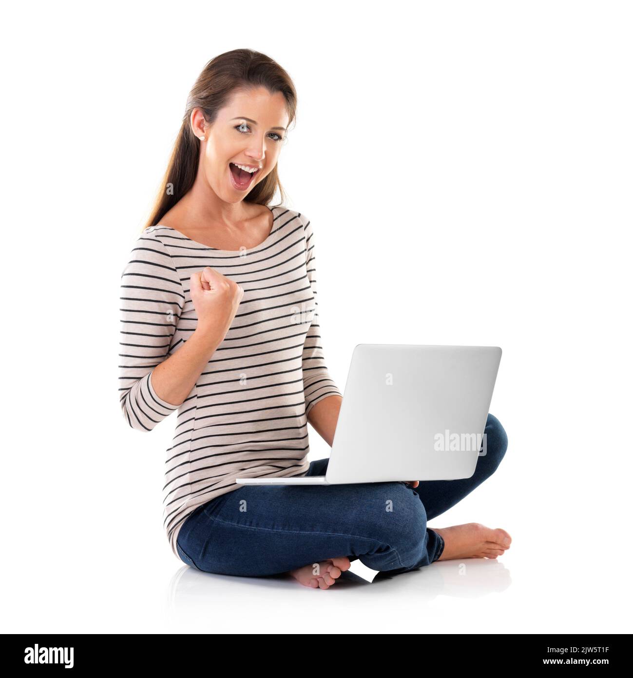What a success. Studio portrait of a young woman using a laptop against ...