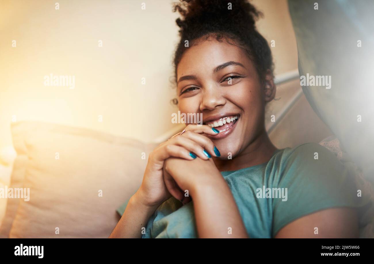 Enjoying a leisurely weekend. Cropped portrait of a young woman sitting ...
