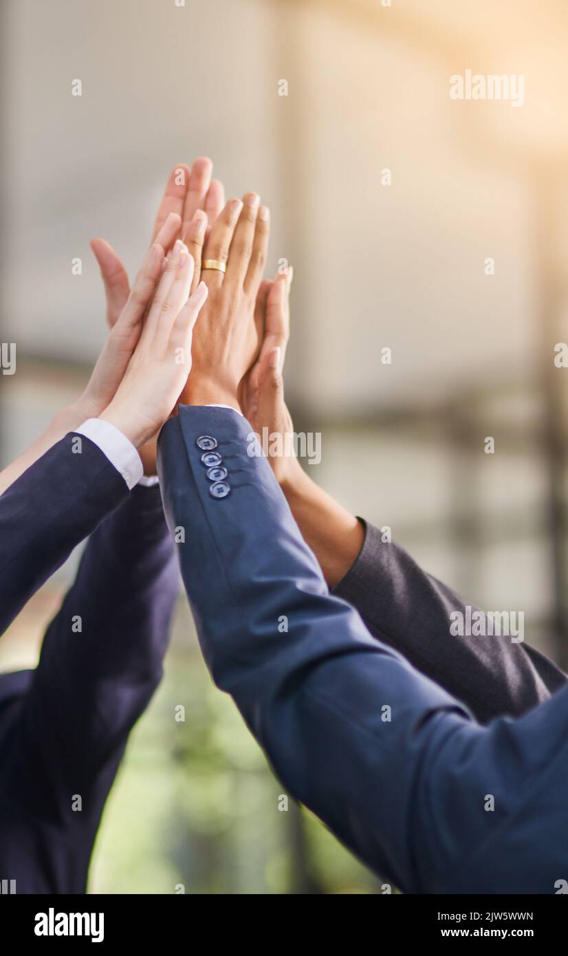 What a success. a group of office workers giving each other a high five ...