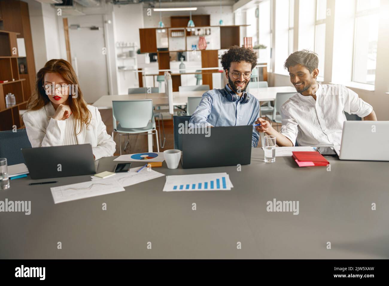 Busy coworkers cooperating and working together at office meeting ...