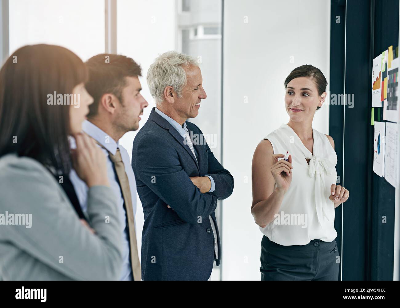 Heres my idea on how we can succeed. a woman giving a presentation to ...