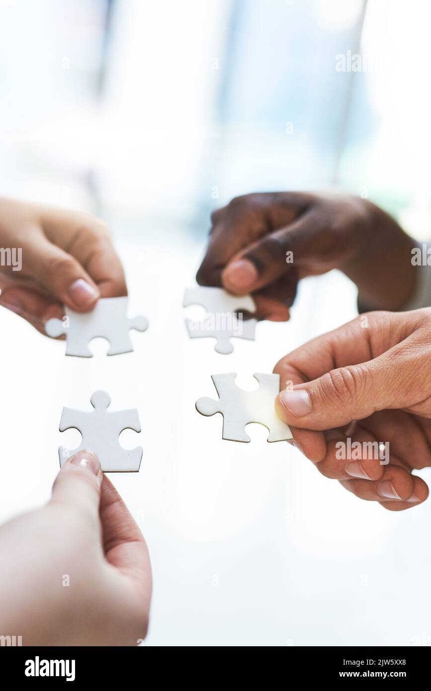 Everyone holds a puzzle piece to the masterpiece. hands putting puzzle ...