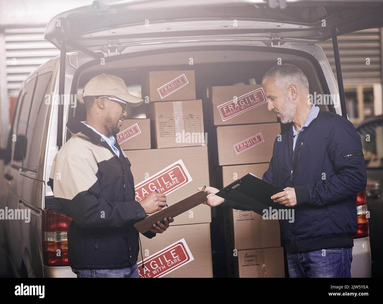 Teamwork ensures a timely delivery. two delivery men having a ...