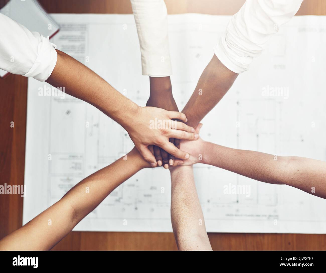 We always share the load. unrecognizable businesspeople joining their ... We always share the load. unrecognizable businesspeople joining their ...