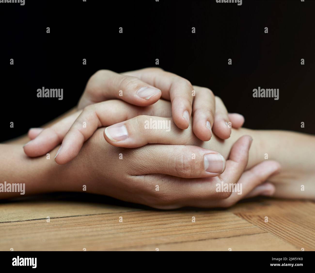 We can get through this together. two people holding hands in comfort ...