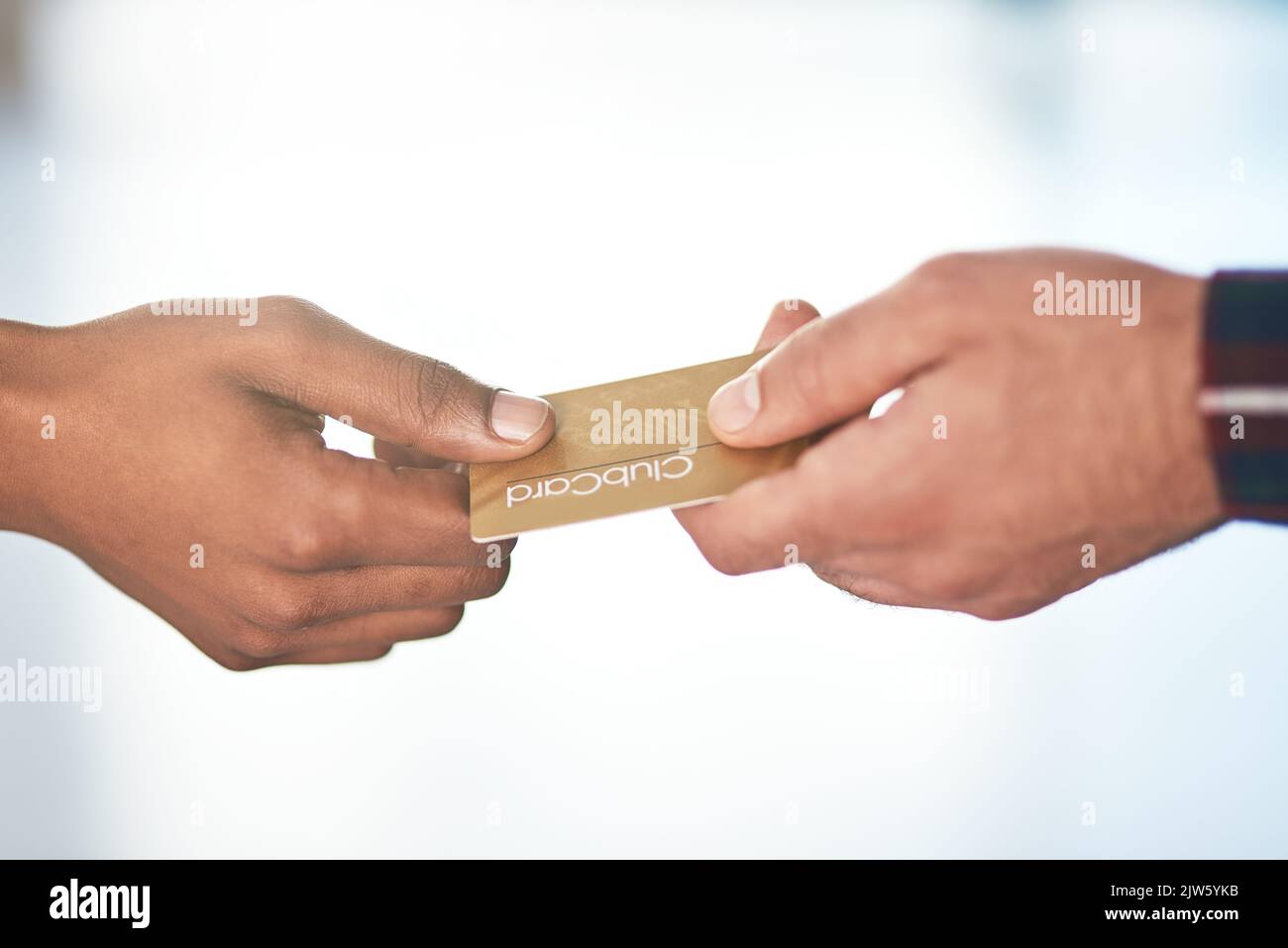 Put it on my card. an unrecognizable man handing over his credit card ...