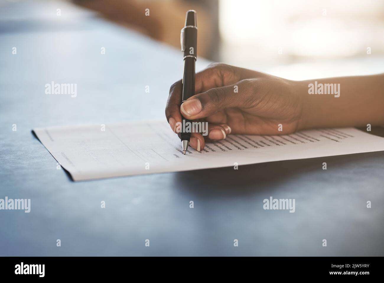 Proofreading the contract. High angle shot of an unrecognizable ...