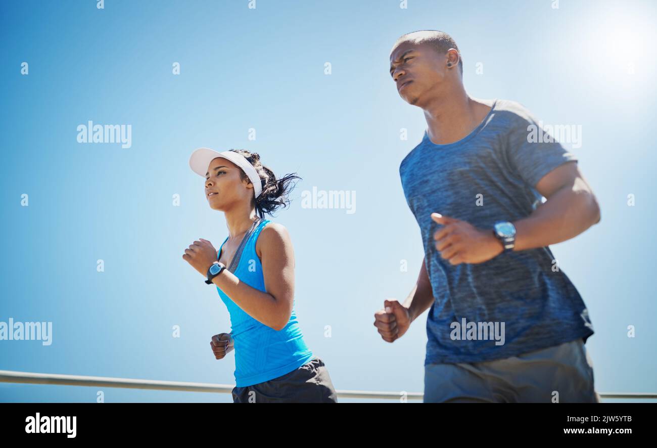 Challenging themselves to push further. a young sporty couple out for a ...