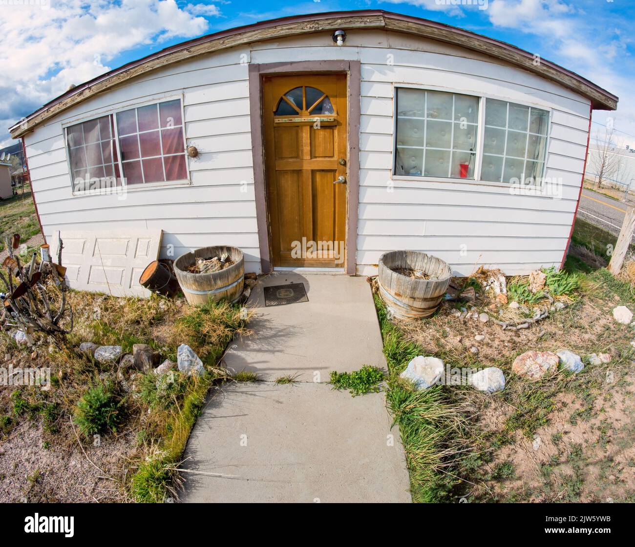 Fisheye view of a run down house with a cluttered yard in rural Utah ...