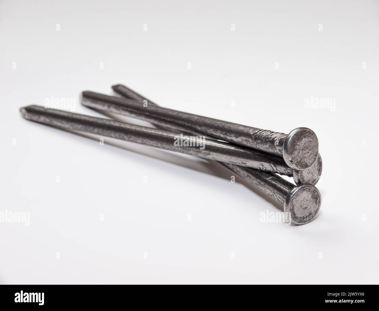 Three nails on a white background Stock Photo - Alamy