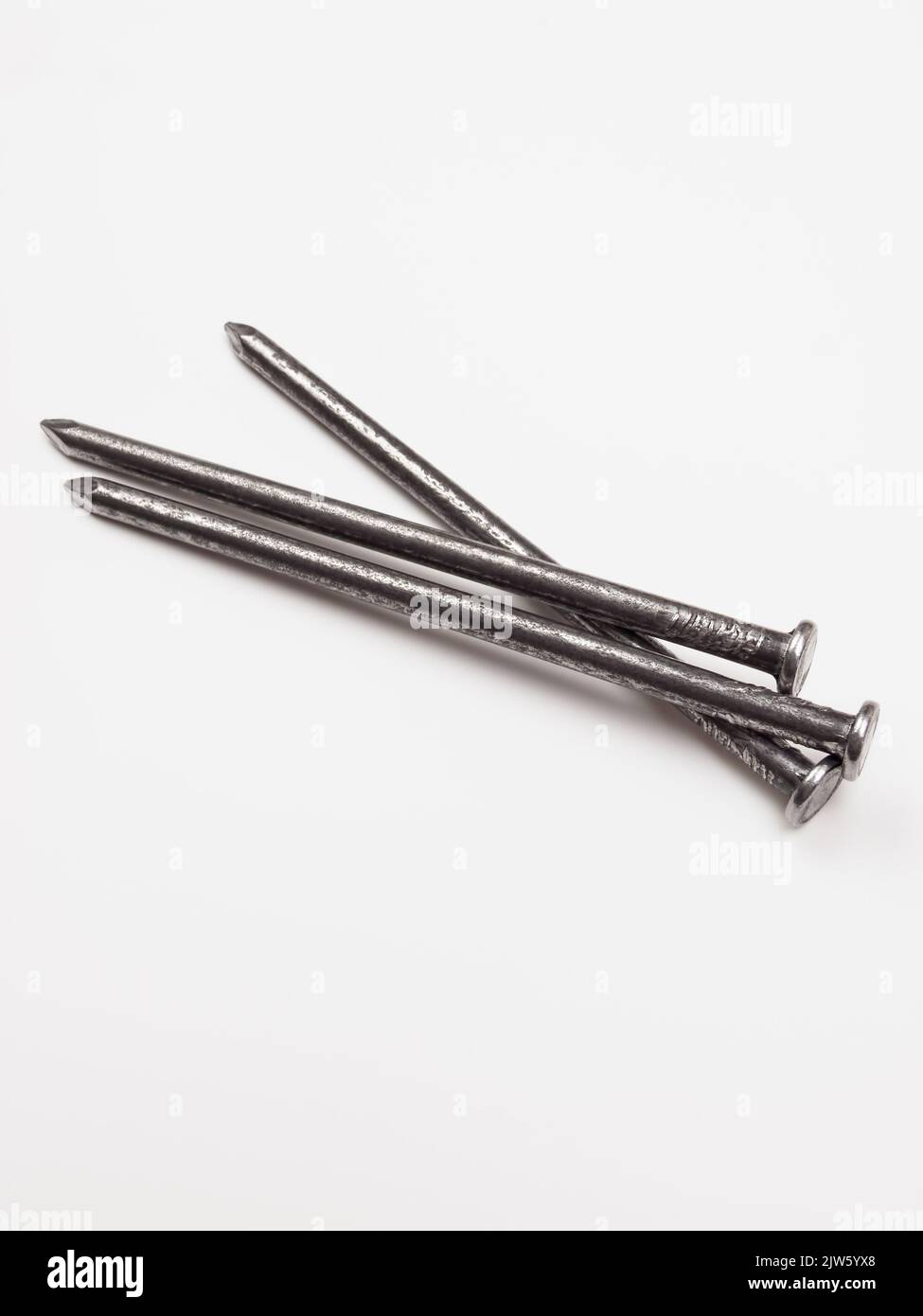 Three nails on a white background Stock Photo - Alamy