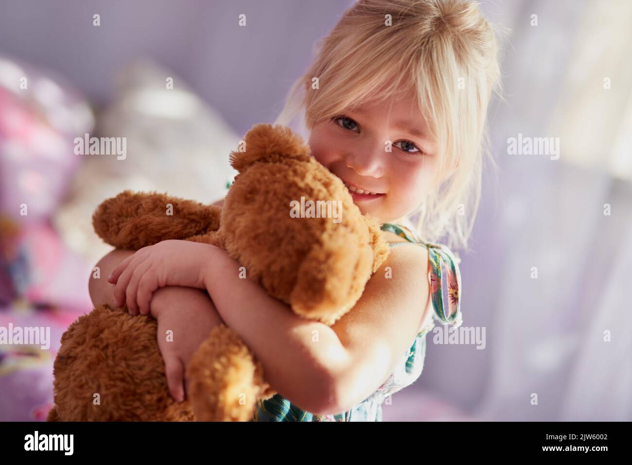 Holding on tight to her fluffiest little friend. Portrait of an ...