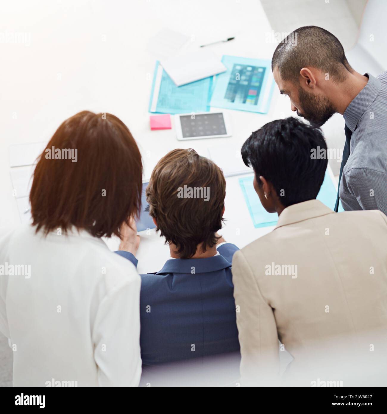 Working together to achieve their goals. businesspeople crowding around ...