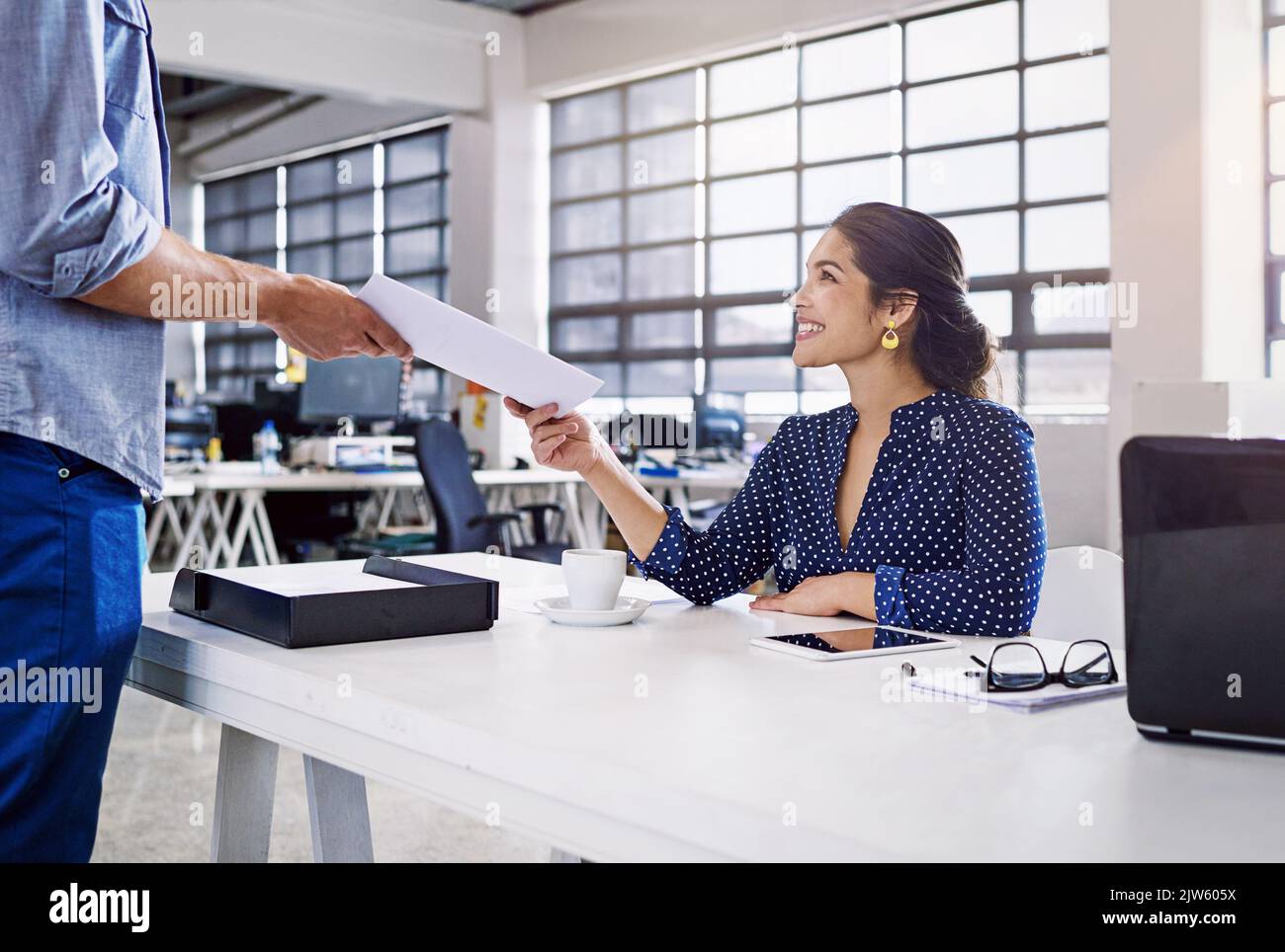 I just need you to sign these please. a young designer handing over ...