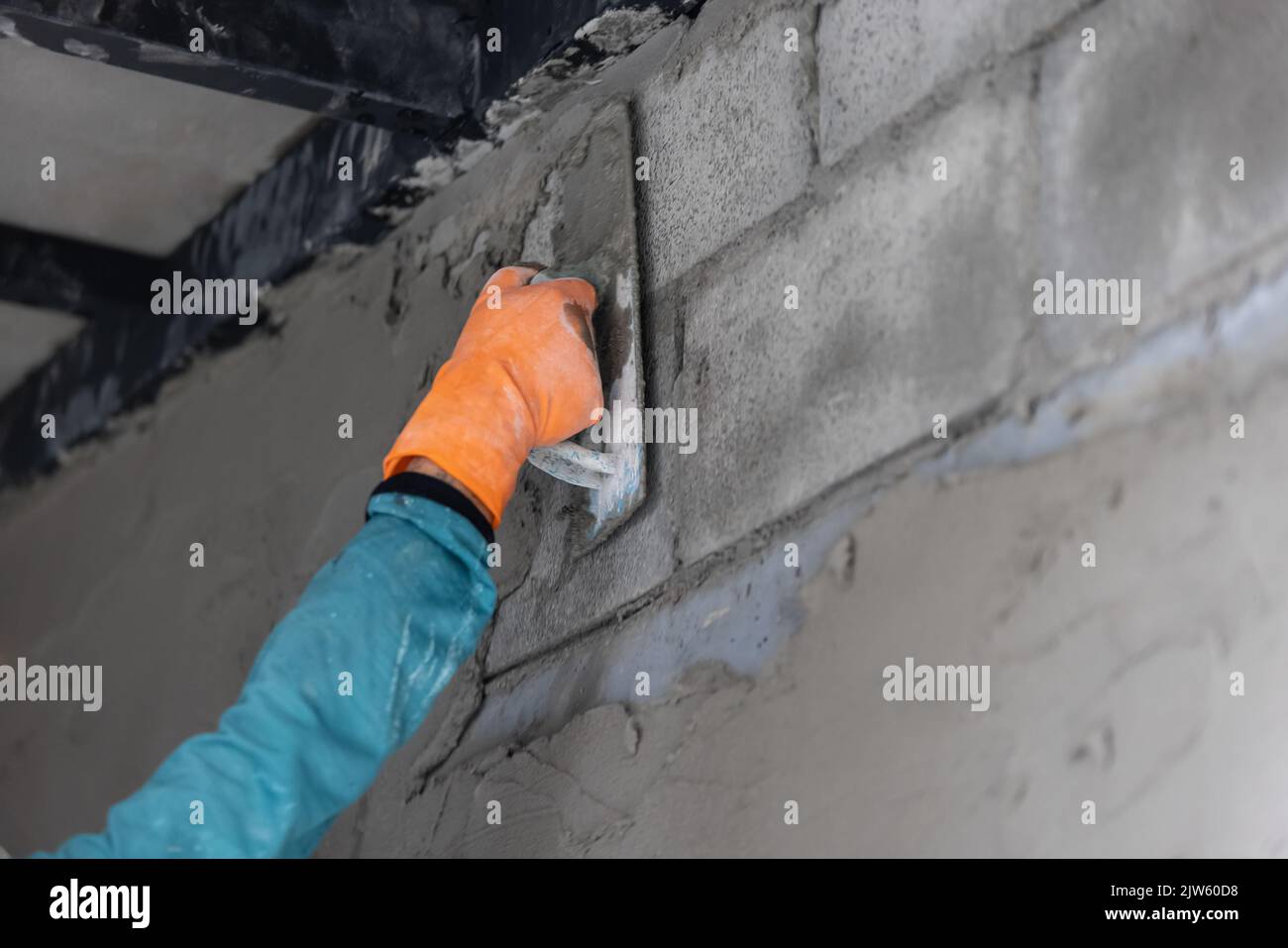 Construction worker plastering wall surface Stock Photo - Alamy