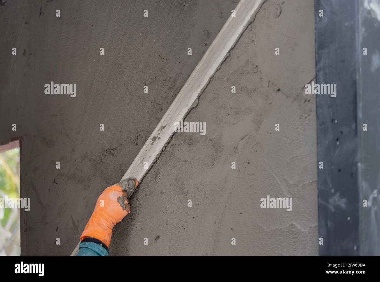 Construction worker plastering wall surface Stock Photo - Alamy