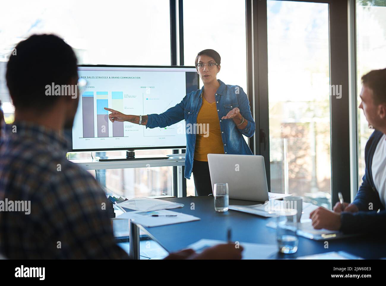 All the facts and figures are right here. a young businesswoman giving ...