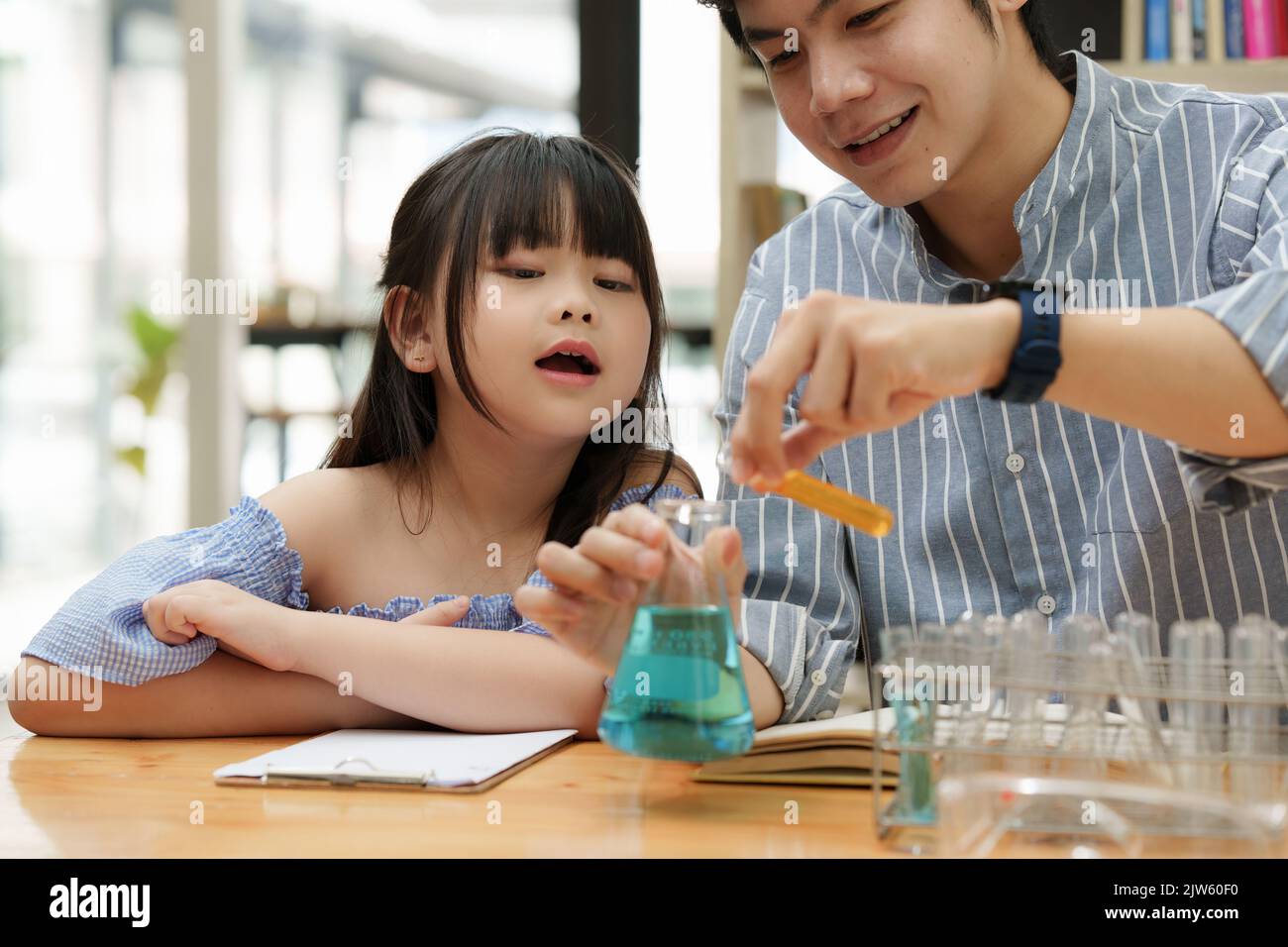 Girls and father doing science experiments. Education science concept ...