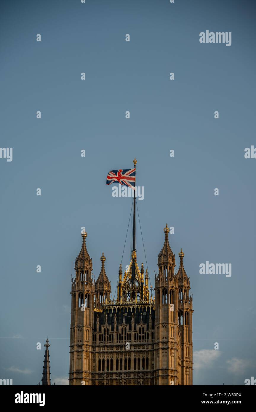 Tower of the UK parliament with the Union Jack flying Stock Photo - Alamy