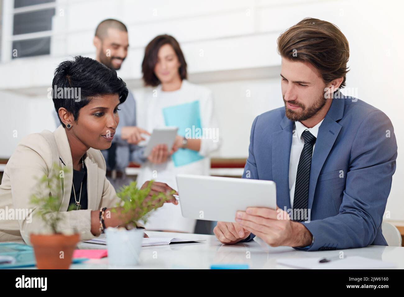 Planning their strategies. businesspeople using digital tablets in an ...