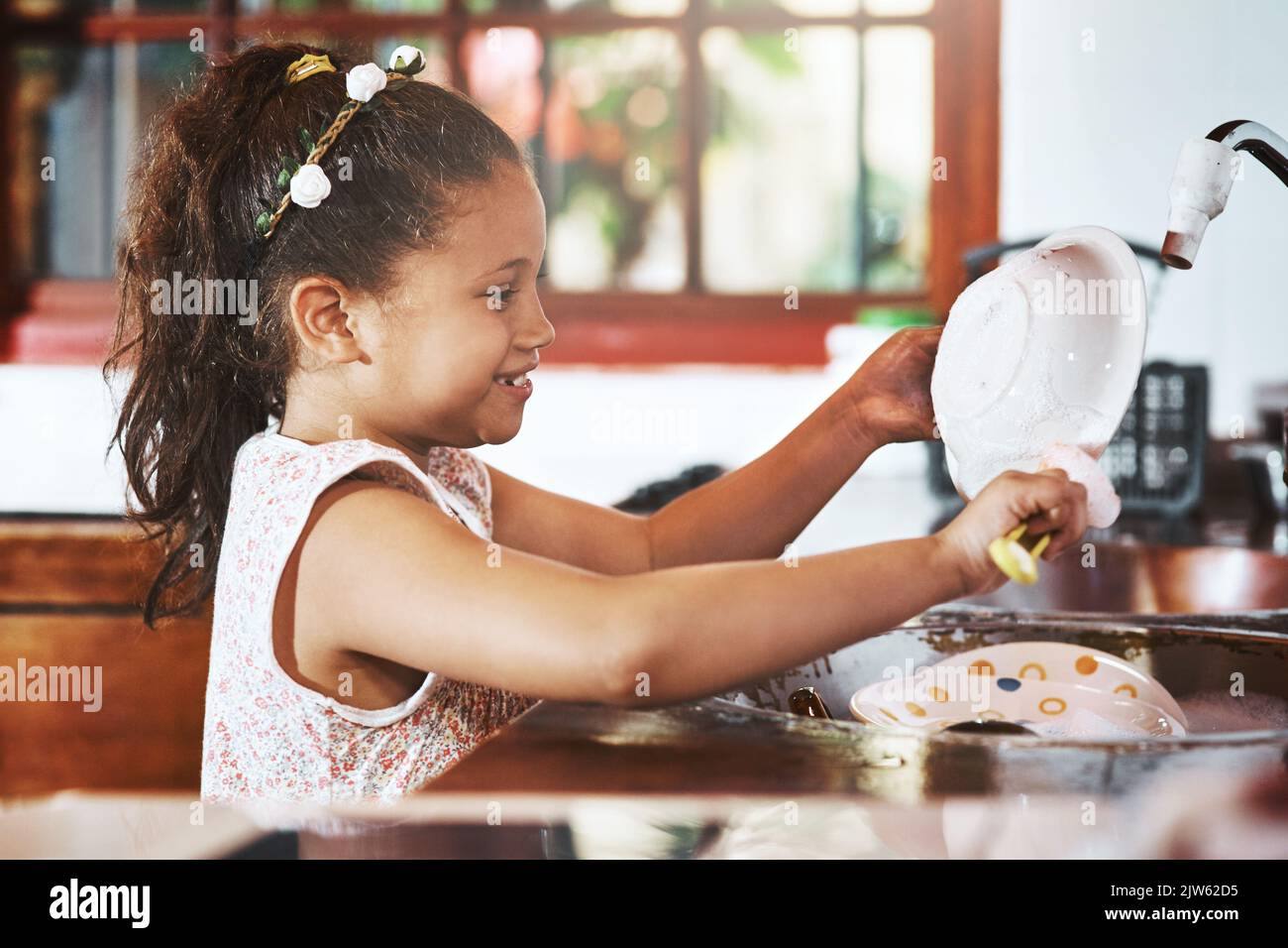 Shes always been a helpful kid. an adorable little girl washing dishes ...