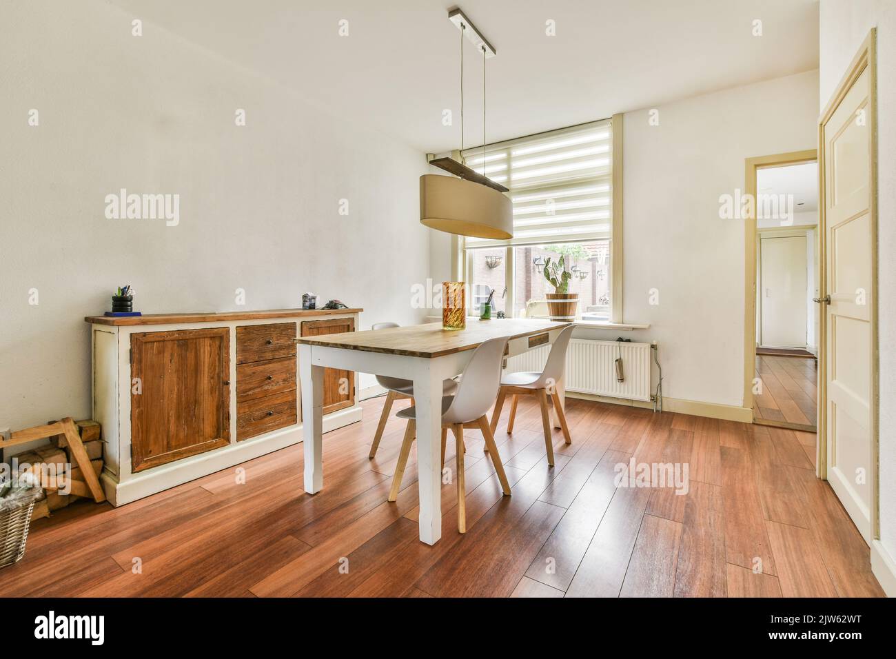 Modern table with chairs near comfortable couch against light walls ...