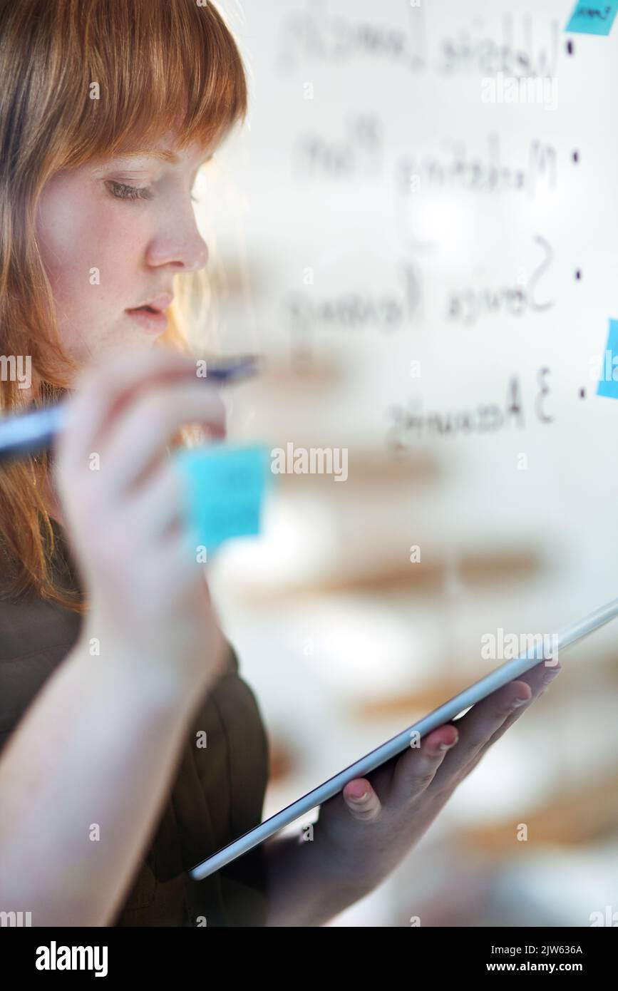 Her strategic plan is taking shape. a young woman creating a plan on ...
