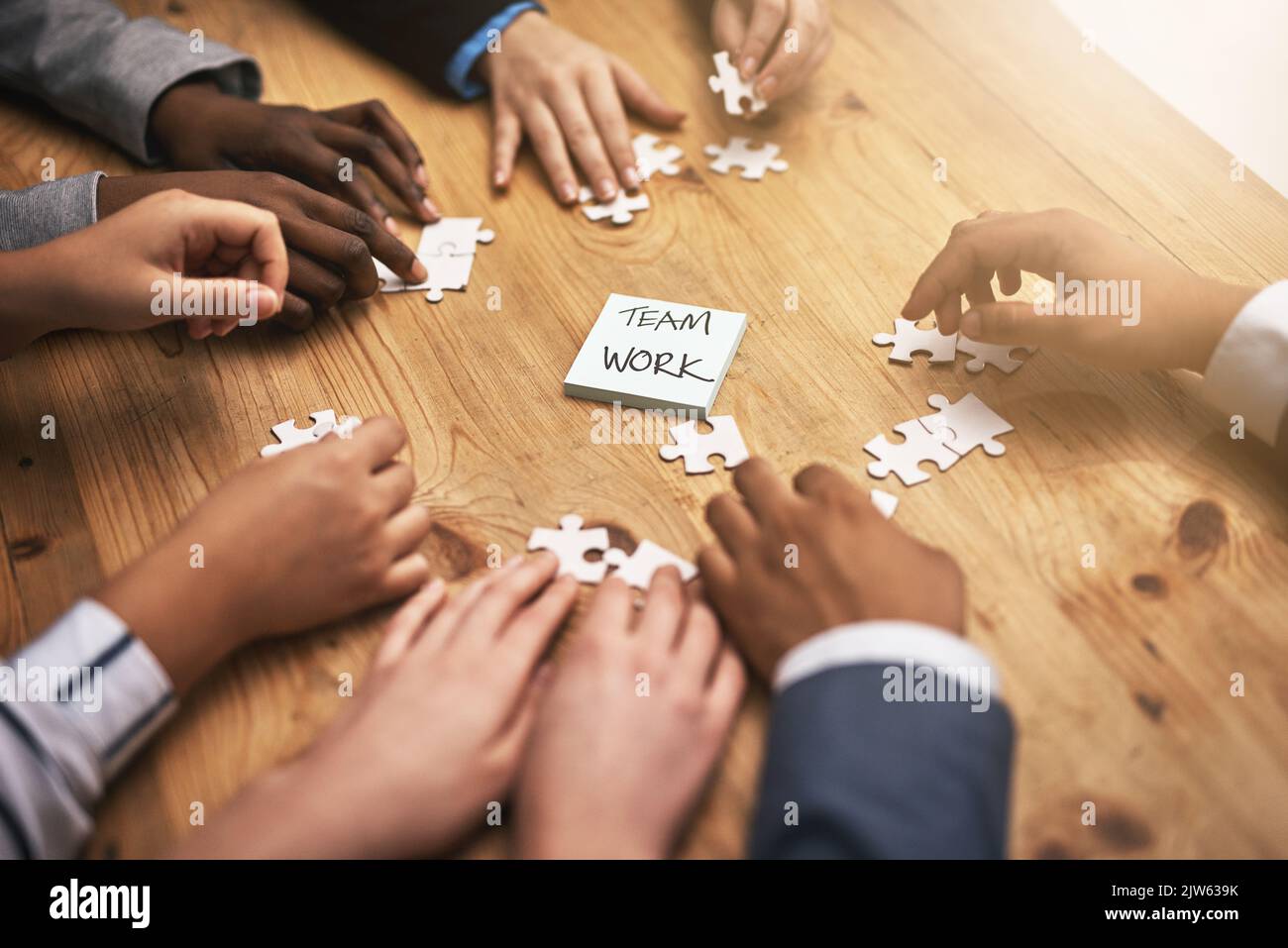 All the pieces are falling into place. High angle shot of a group of unrecognizable coworkers ...