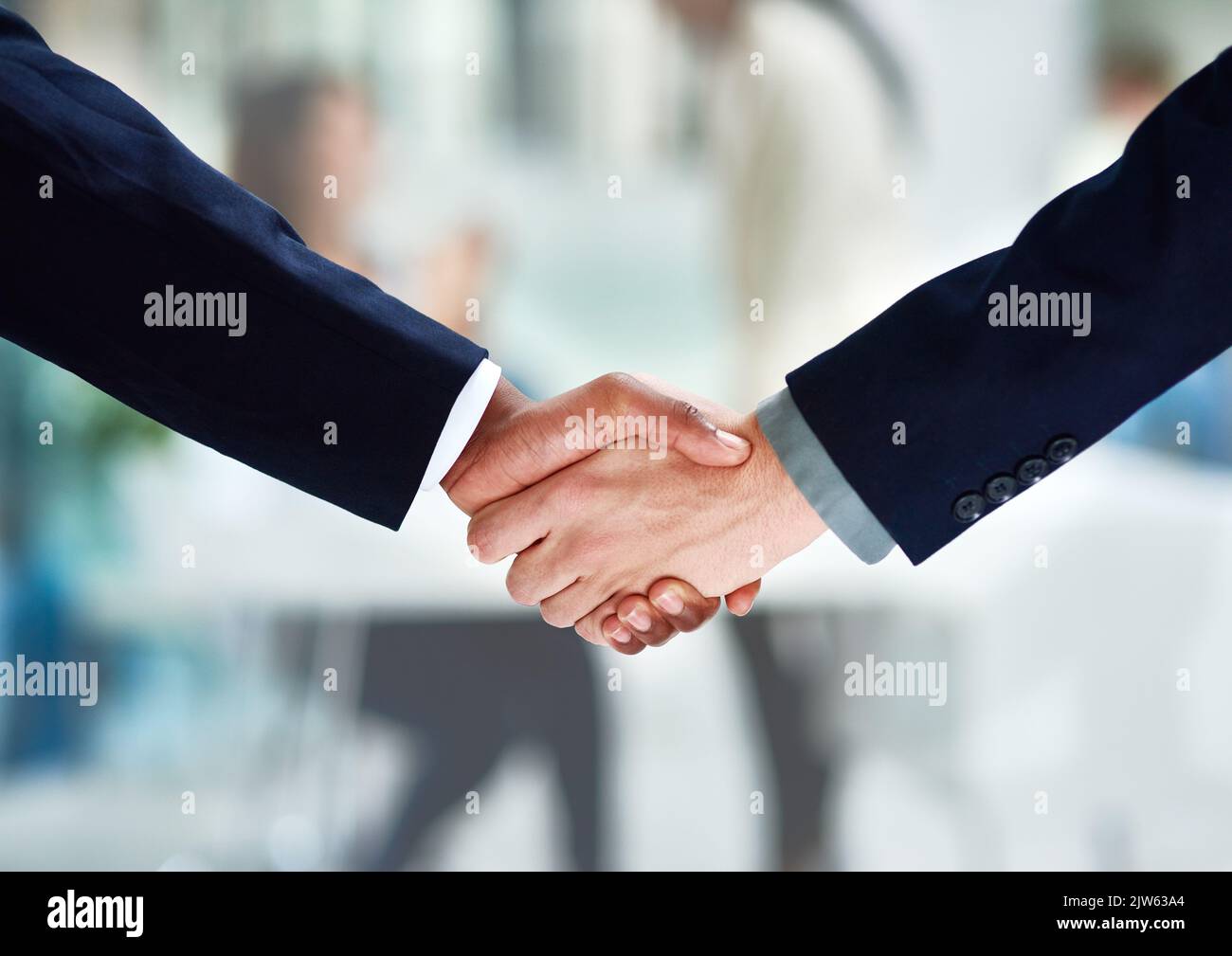 Another successful negotiation. two businessmen shaking hands Stock Photo - Alamy