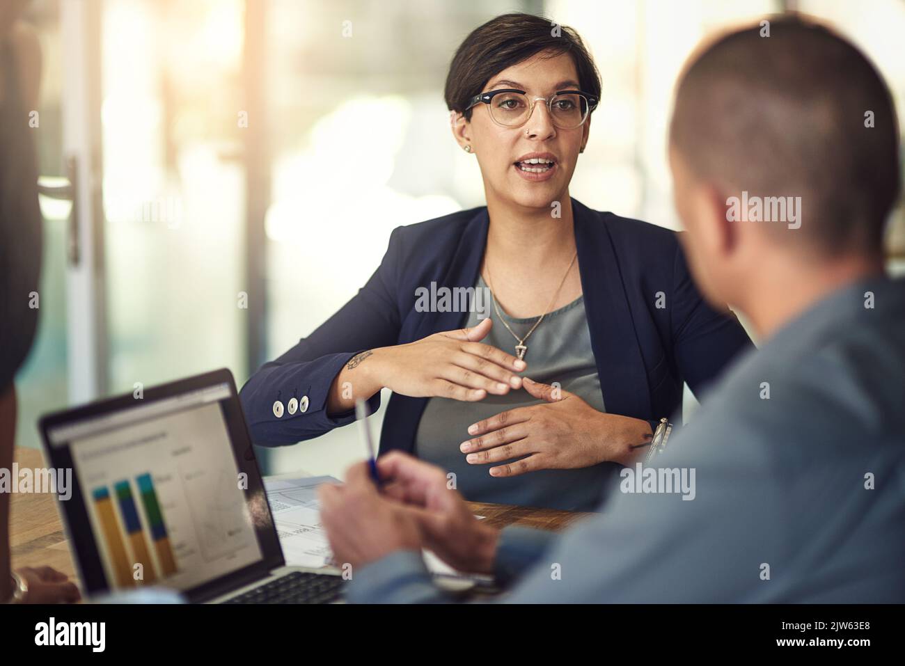 Giving her input. colleagues having a discussion in a boardroom Stock ...