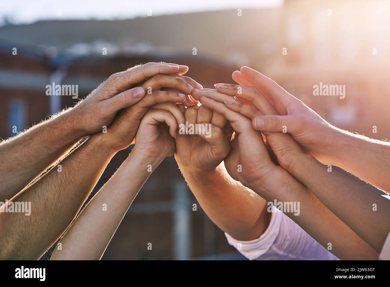 Similarity through difference. a group of hands holding on to each ...