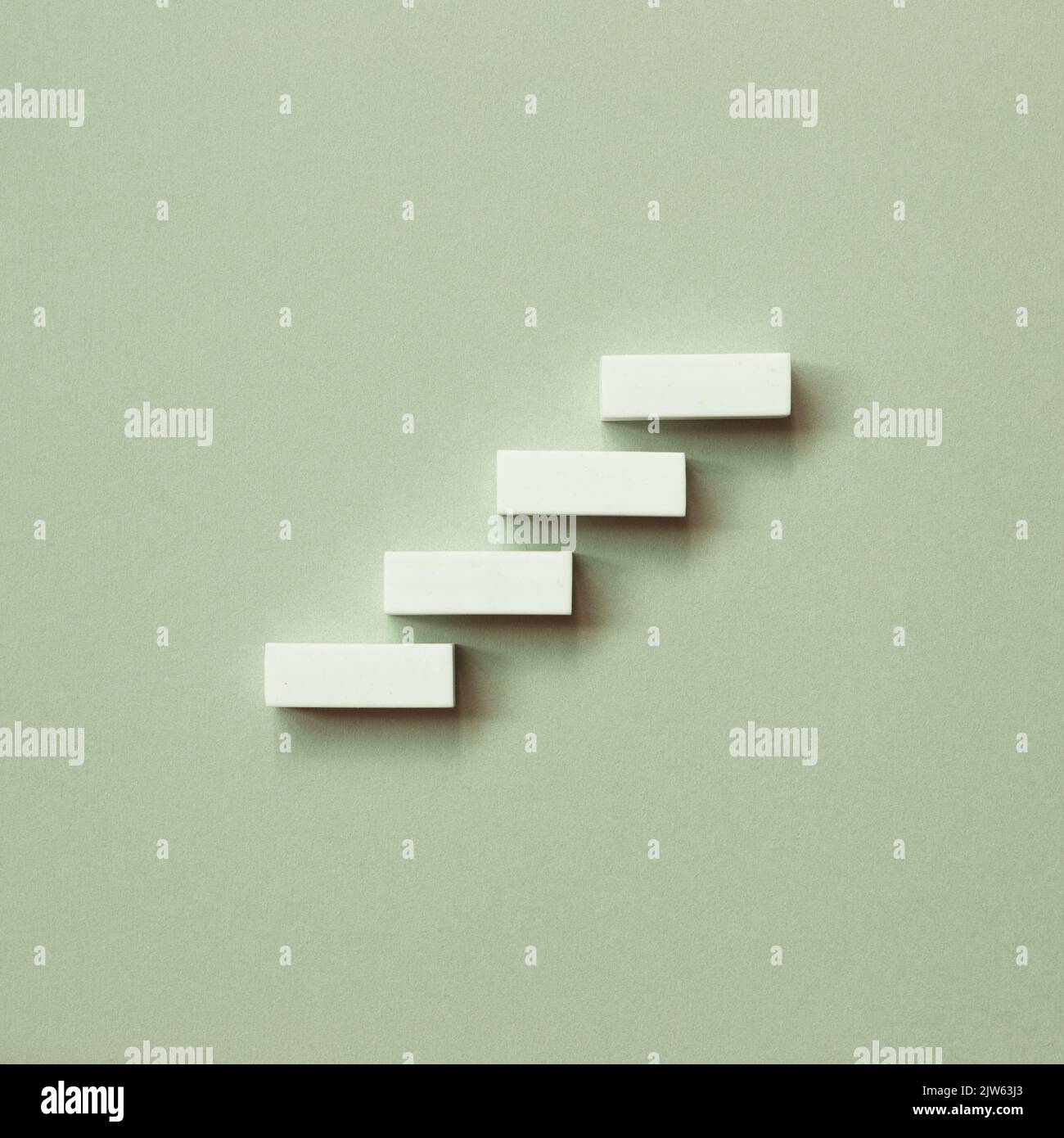 Abstract stairs or steps concept on green background Stock Photo - Alamy