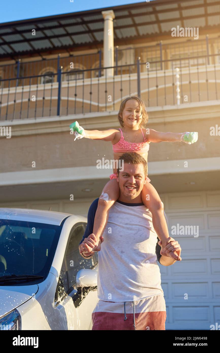 Feeling on top of the world. Portrait of a father carrying his daughter ...