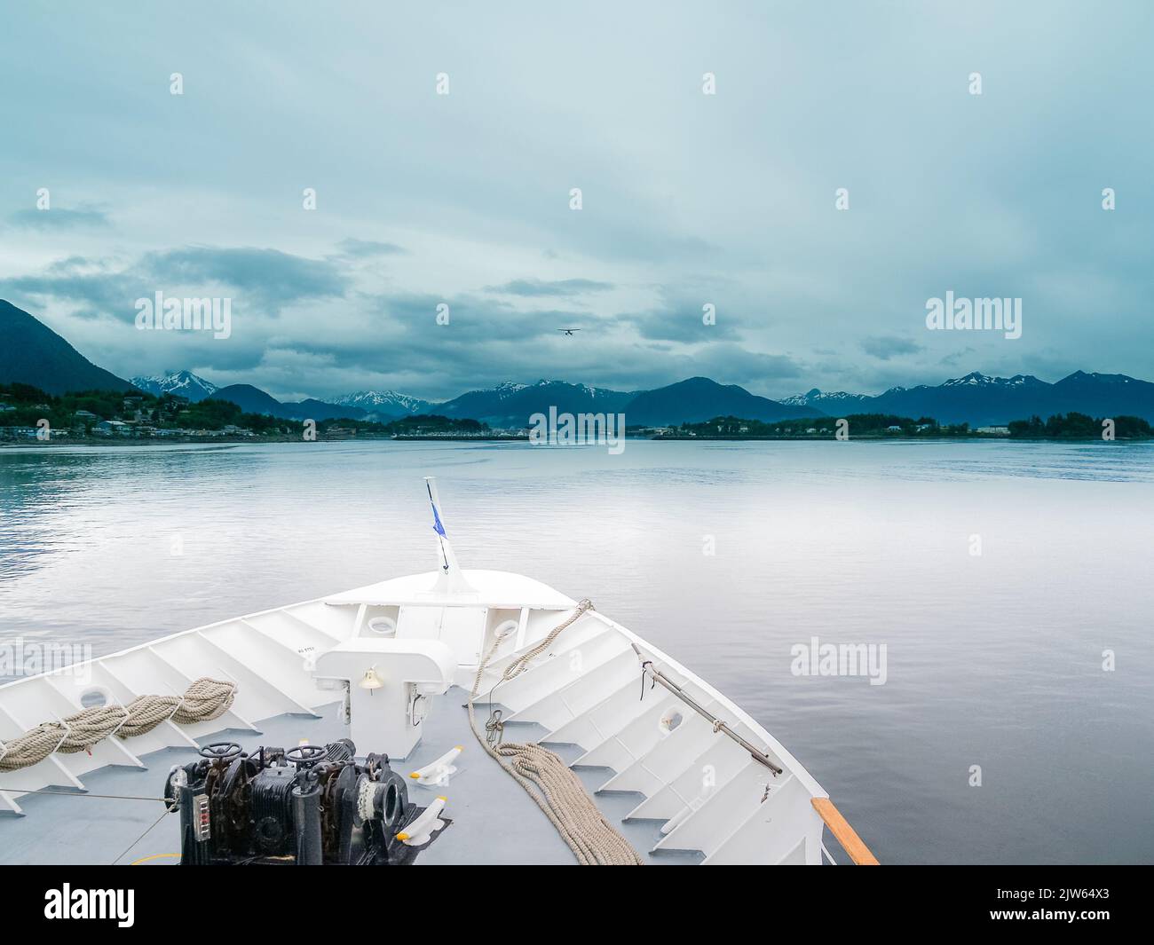 Bright white structure and bow of small cruise-ship heading into ...