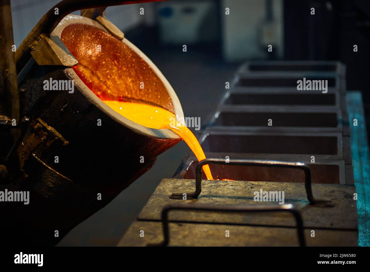 Pouring red liquid silver from bucket in induction oven Stock Photo - Alamy