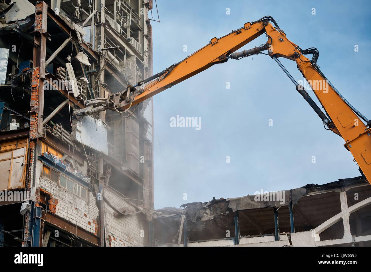 Hydraulic scissors on rig of crane cut building on site Stock Photo - Alamy