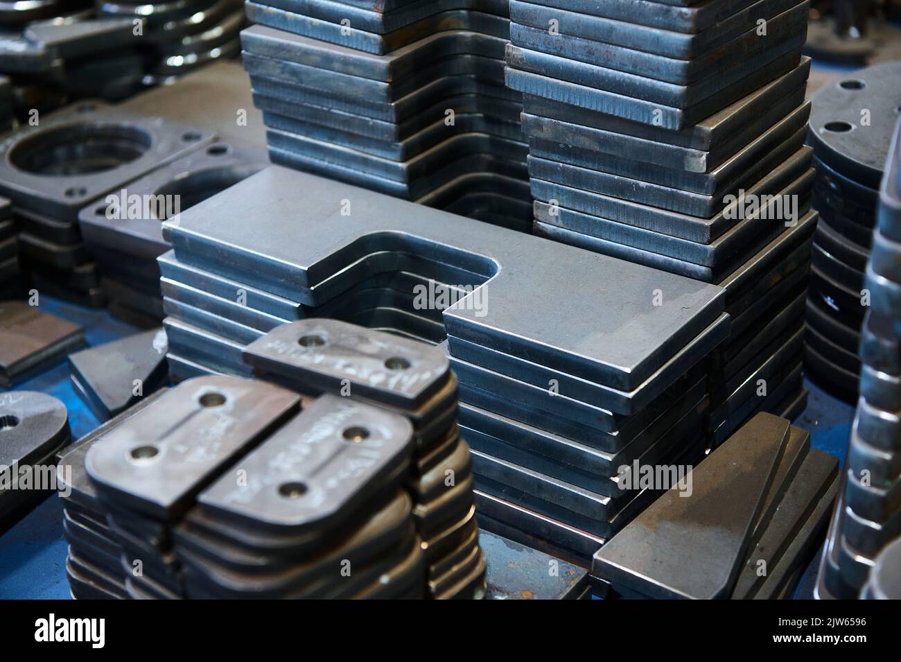 Group of workpieces cut of metal sheet in storehouse Stock Photo - Alamy