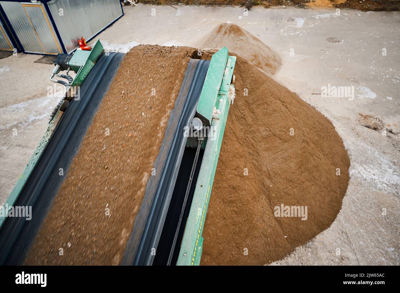 Soil falls from conveyor of crushing and sorting complex Stock Photo ...