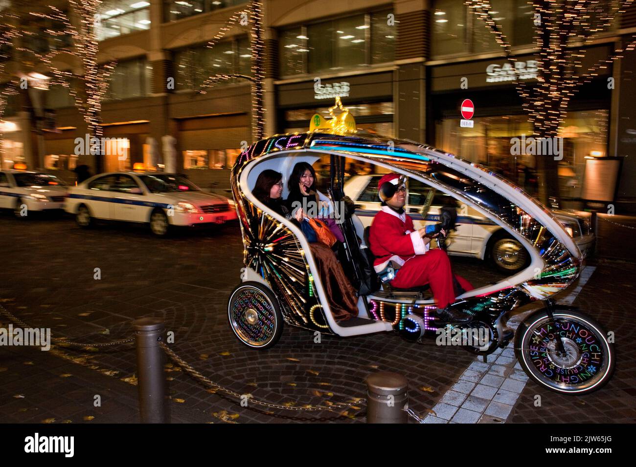 Pedicab w passengers evening Marunouchi Tokyo Japan Stock Photo - Alamy