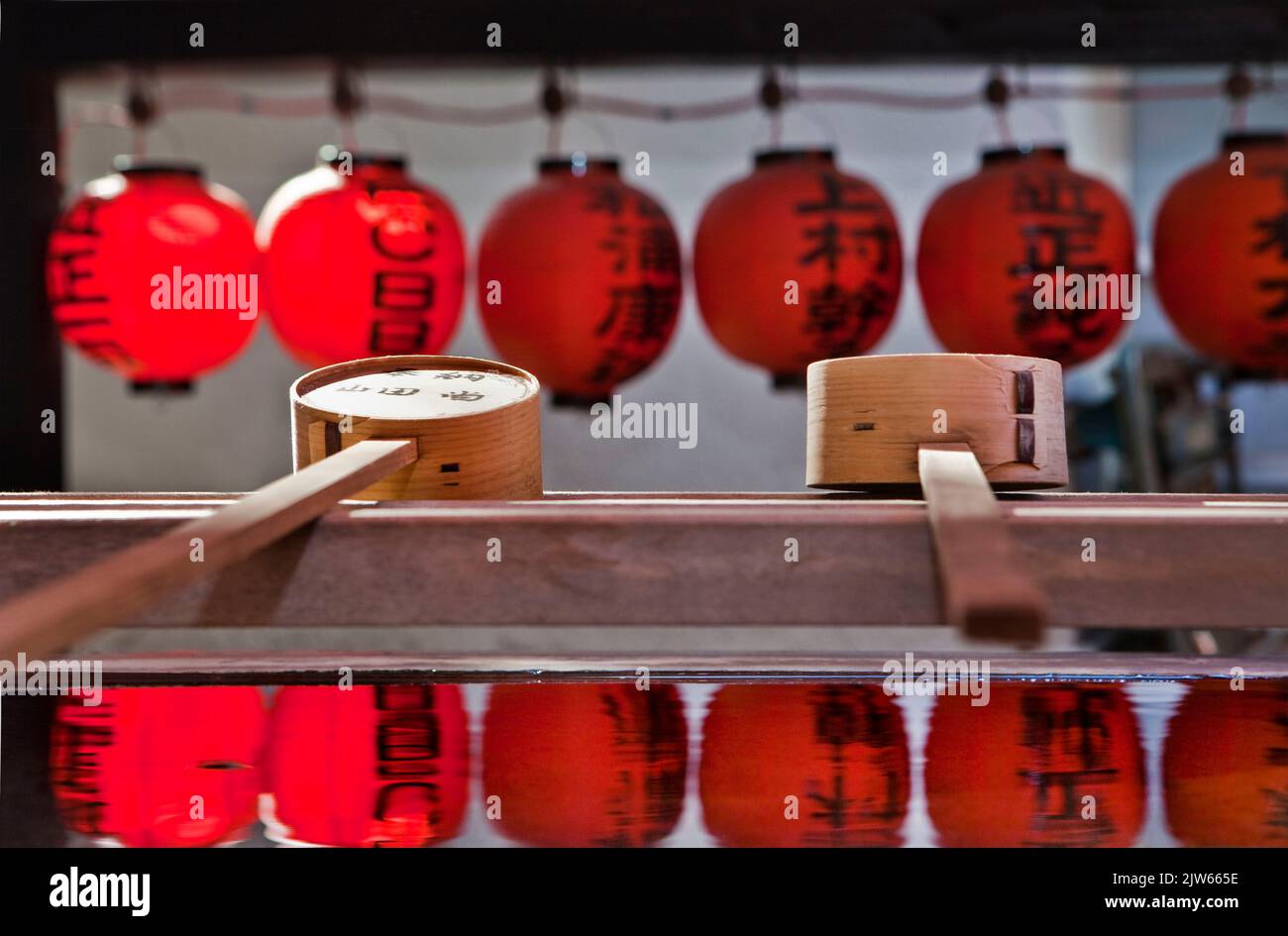 Reflection of lanterns basin w water dippers Toyosaka Inari Shrine ...