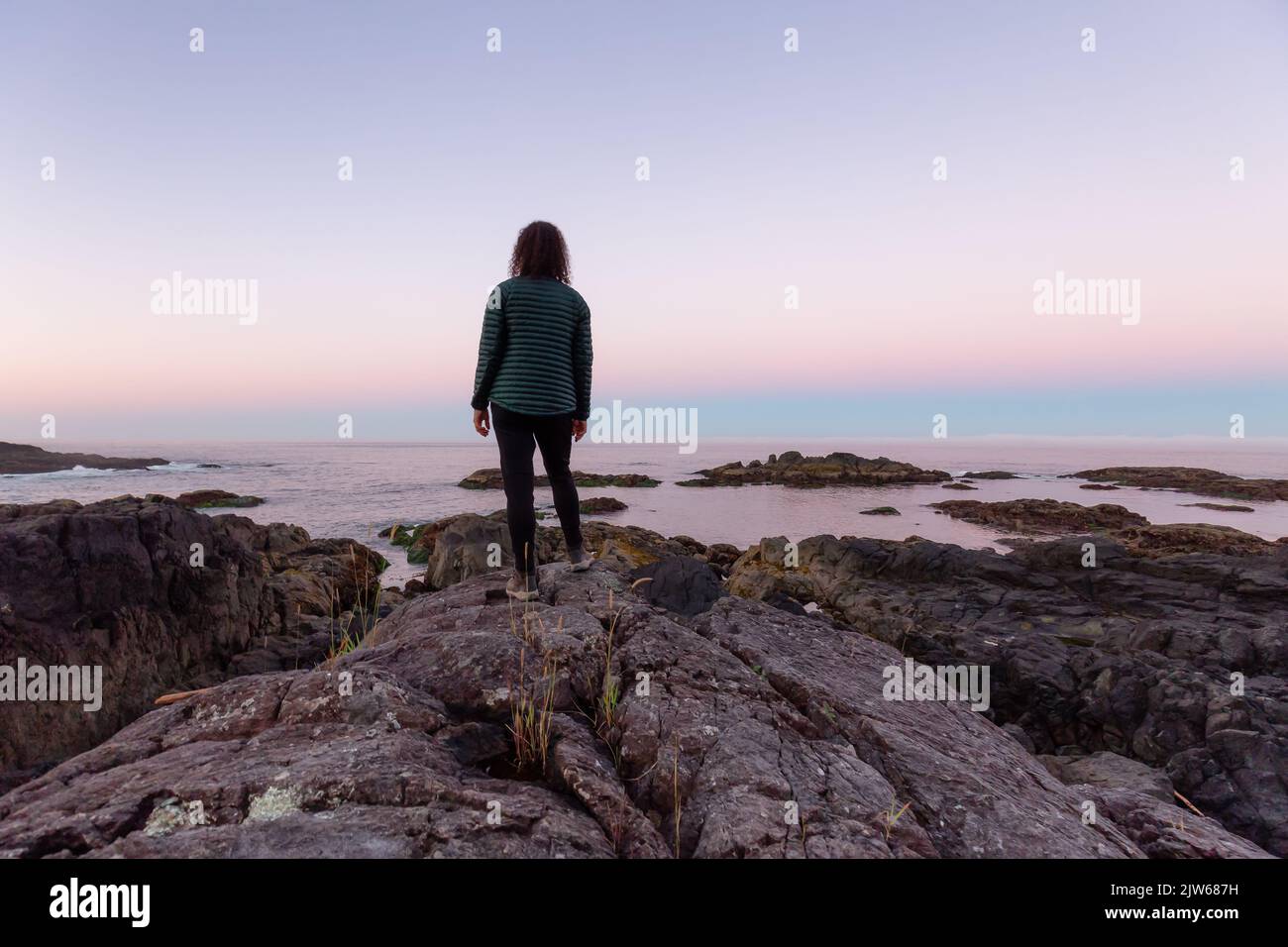 Adventurous Women Standing and Looking out to Ocean in Canadian Nature ...