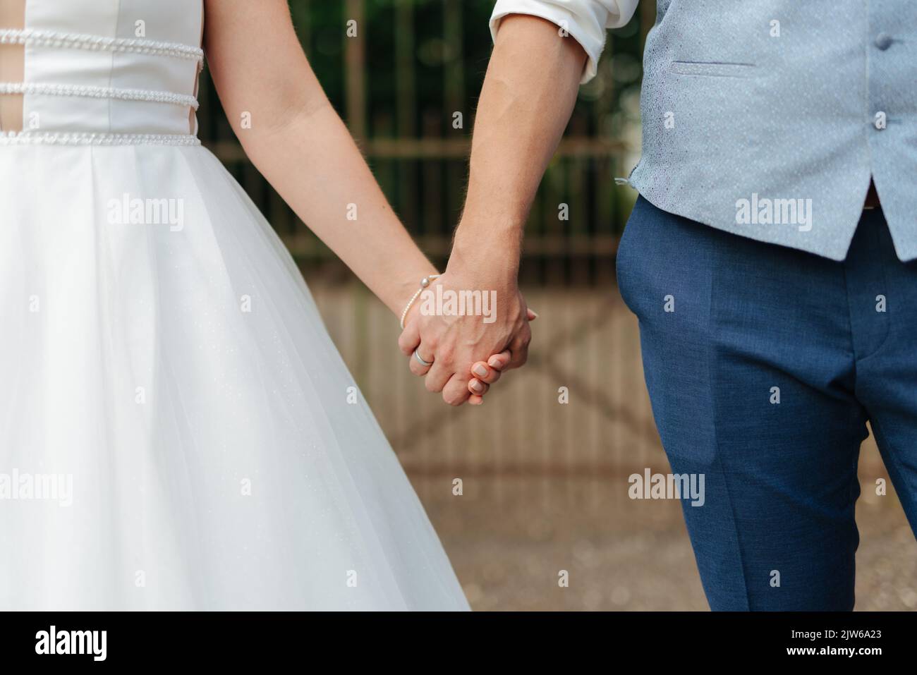 Bride and Groom holding hands during their wedding ceremony Stock Photo ...