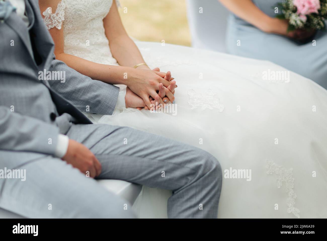Bride and Groom holding hands during their wedding ceremony Stock Photo ...