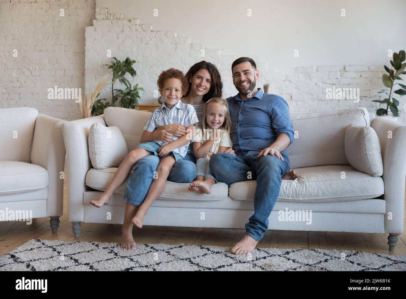 Happy well-being homeowners family pose on camera at home Stock Photo ...